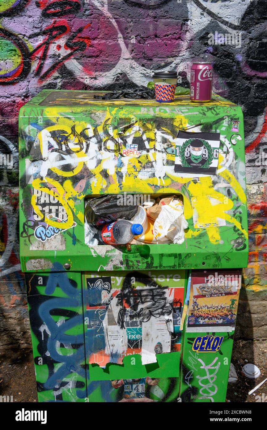 London, UK. Heavily graffitied and barely recognisable litter bin on ...