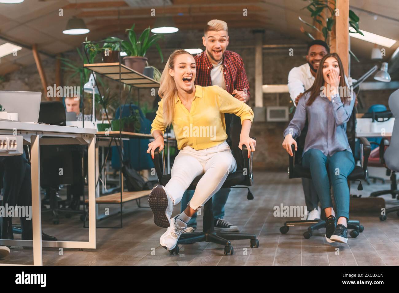 Group of People Sitting Around a Desk Stock Photo - Alamy