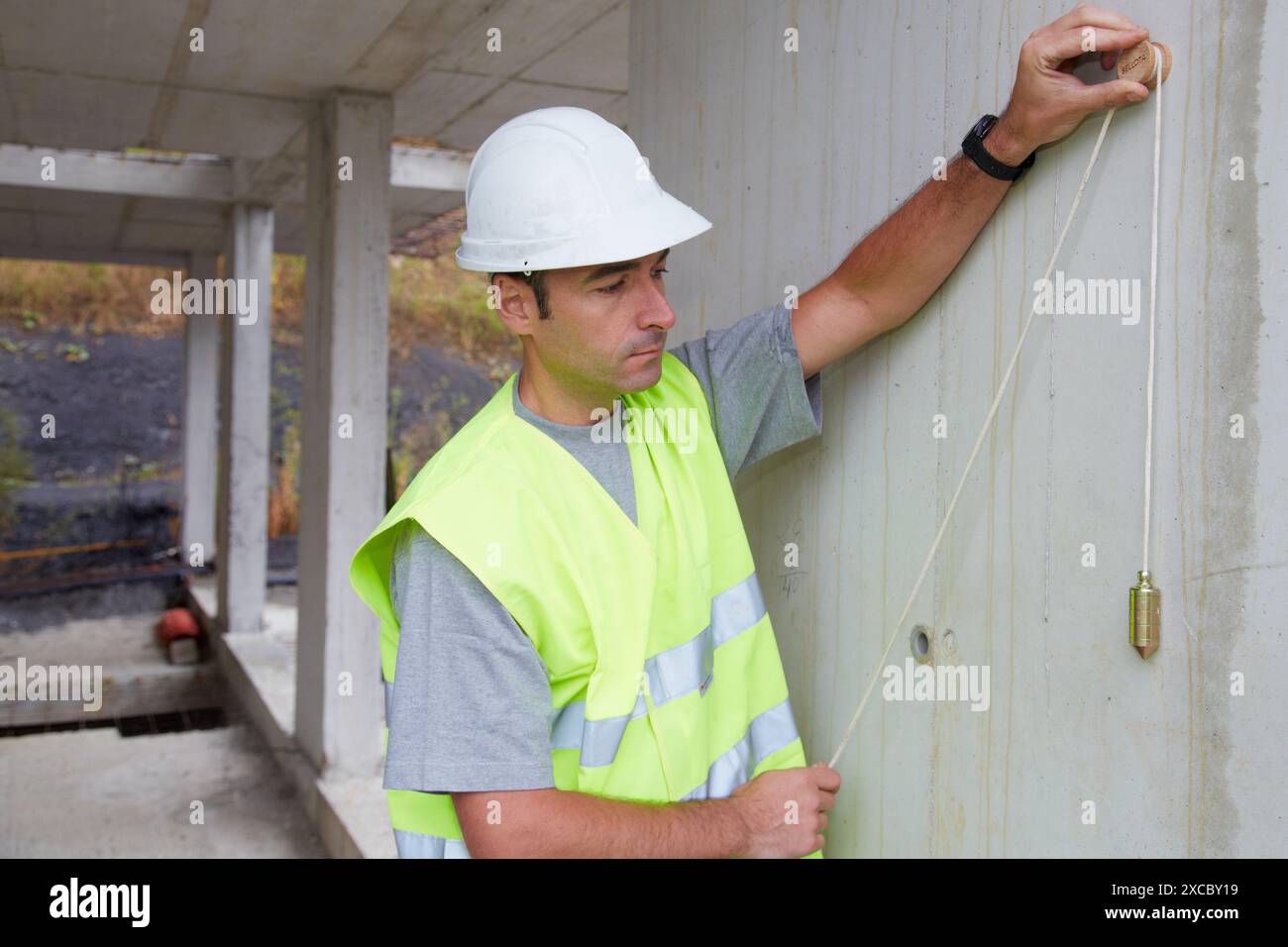 Worker with protective equipment, PPE, Checking and aligning vertical ...