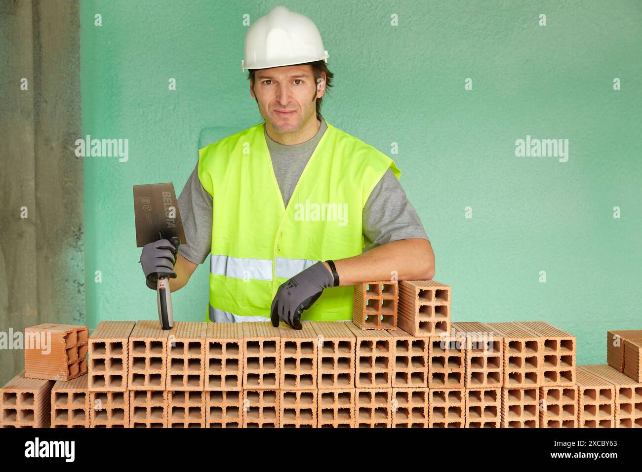 Bricklayer with trowel making a brick wall, Mason with personal ...
