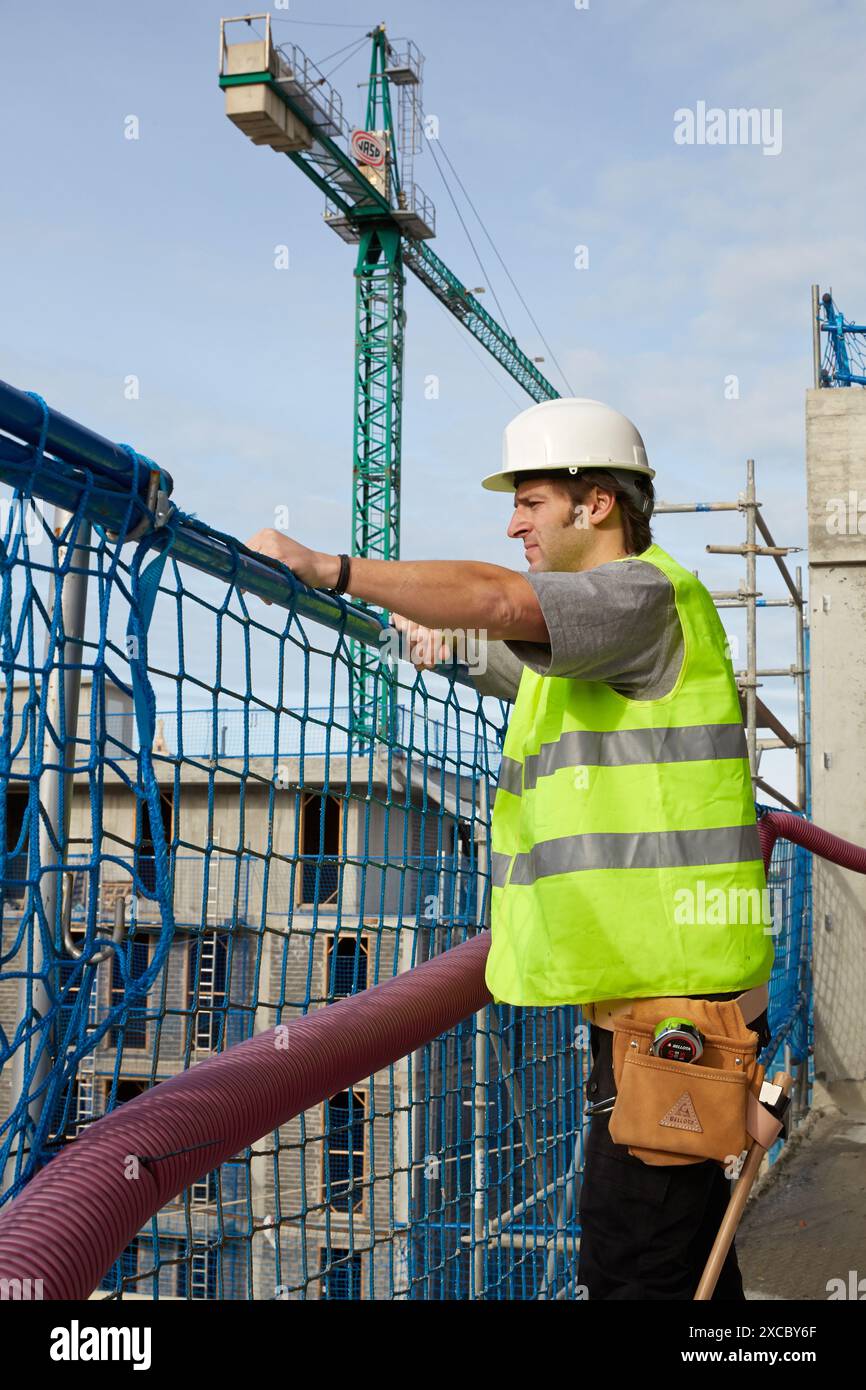 Mason, Bricklayer with personal protective equipment, PPE, Apartment ...
