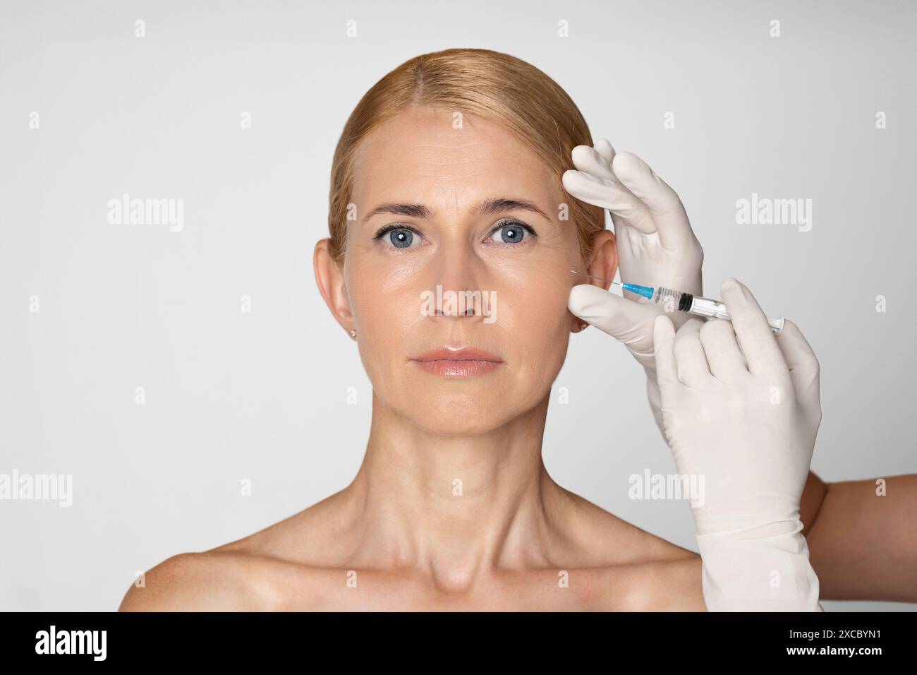 Woman Receiving Facial Injection With Needle, White Background Stock ...