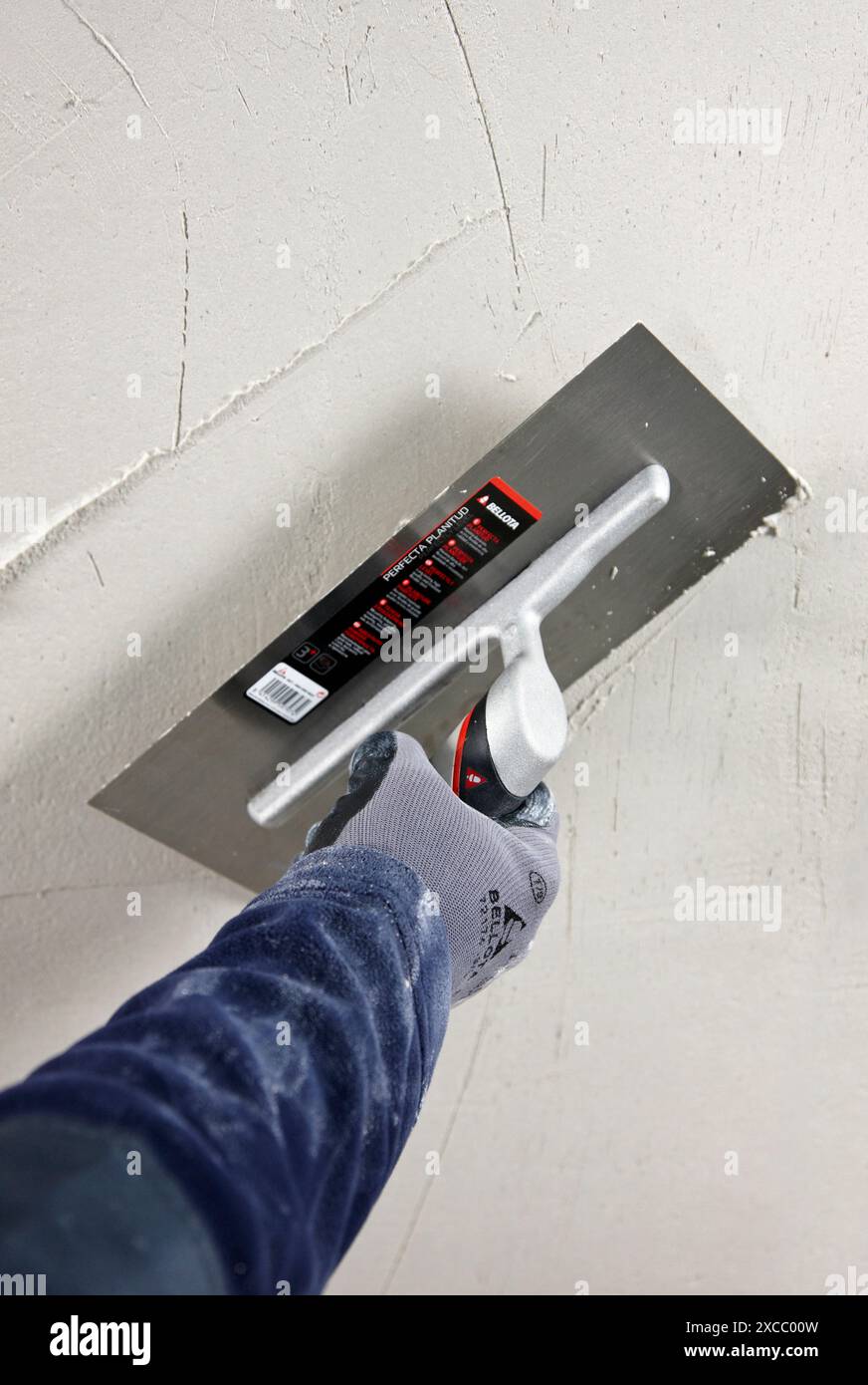 Rendering wall using trowel, new homes under construction, construction ...