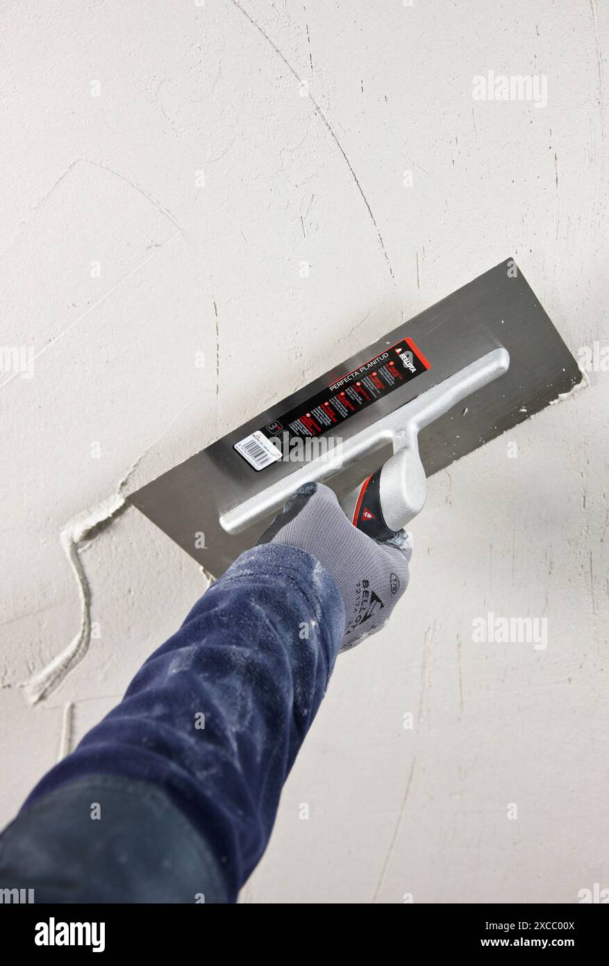 Rendering wall using trowel, new homes under construction, construction ...