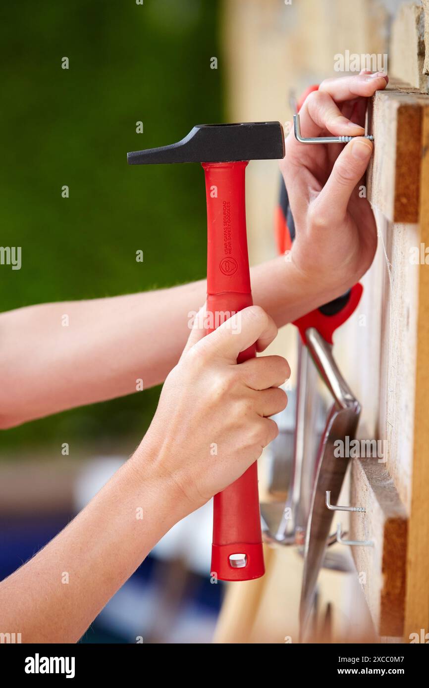 Woman with hammer nailing a spike. DIY Stock Photo - Alamy