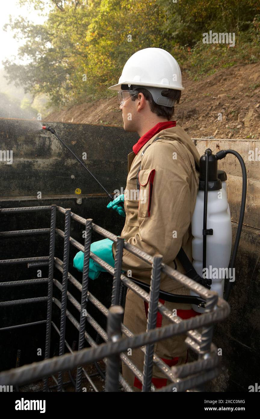 Applying form release agents with sprayer, concrete formworks Stock ...