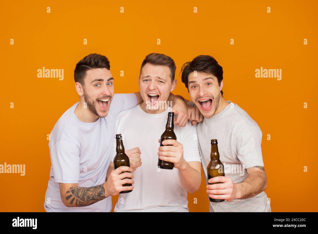Three men holding beer and celebrating meeting over background Stock ...