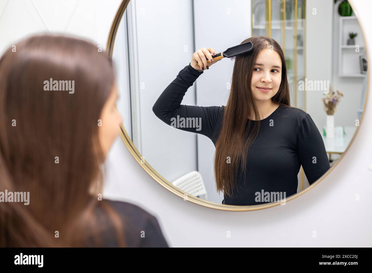 Beautiful female brushing their hair hi-res stock photography and ...