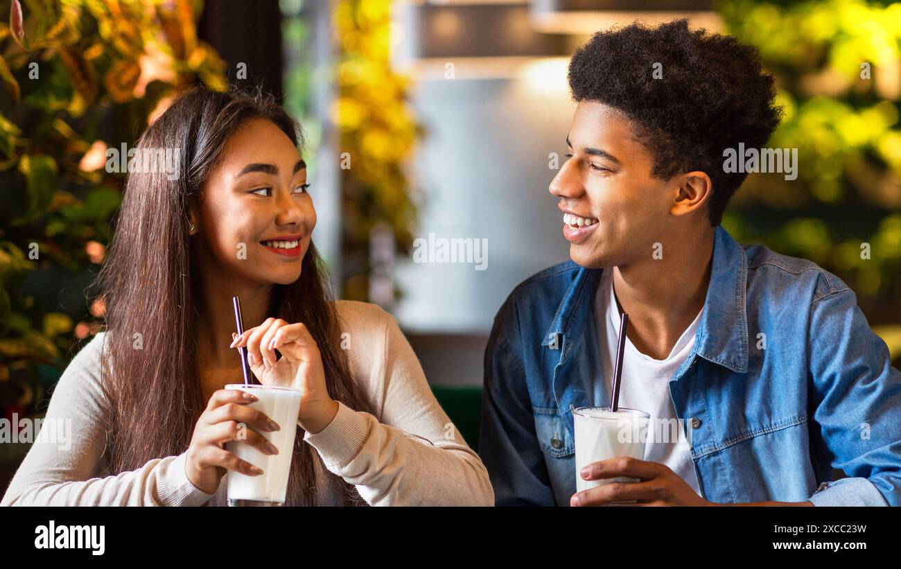 African American Guy and Girl Drinking Milkshake in a Cafe Stock Photo ...