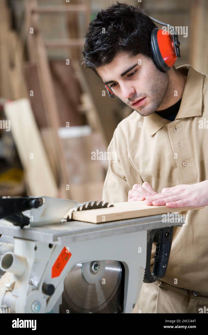 Carpenter cutting wood with electrical saw. Wood carpentry Stock Photo ...