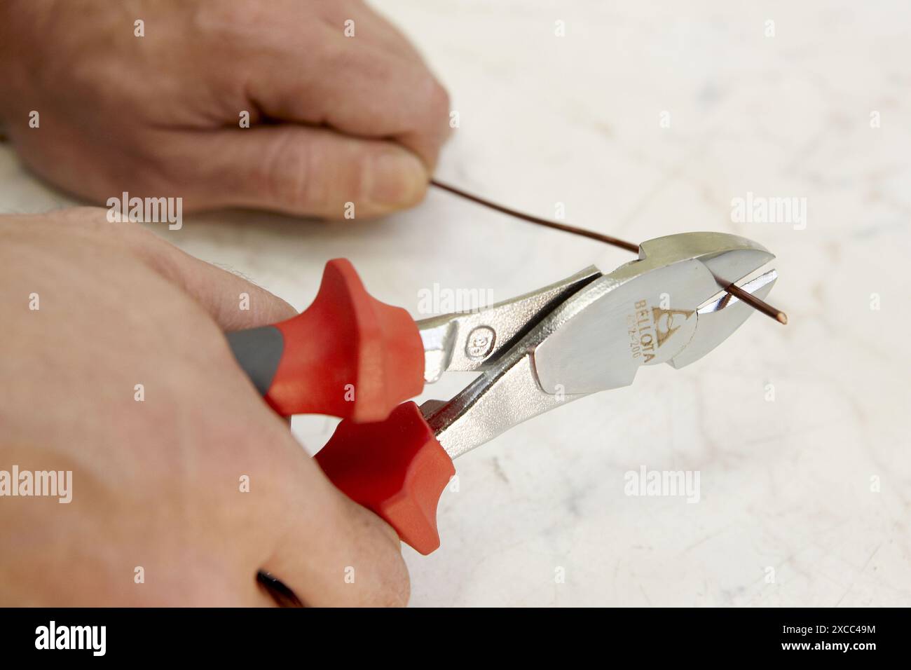 Male hands cutting wire hi-res stock photography and images - Alamy