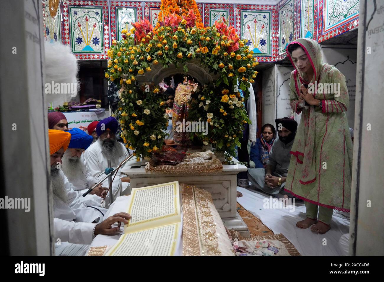 Sikh pilgrims perform rituals during a ceremony to observe the ...