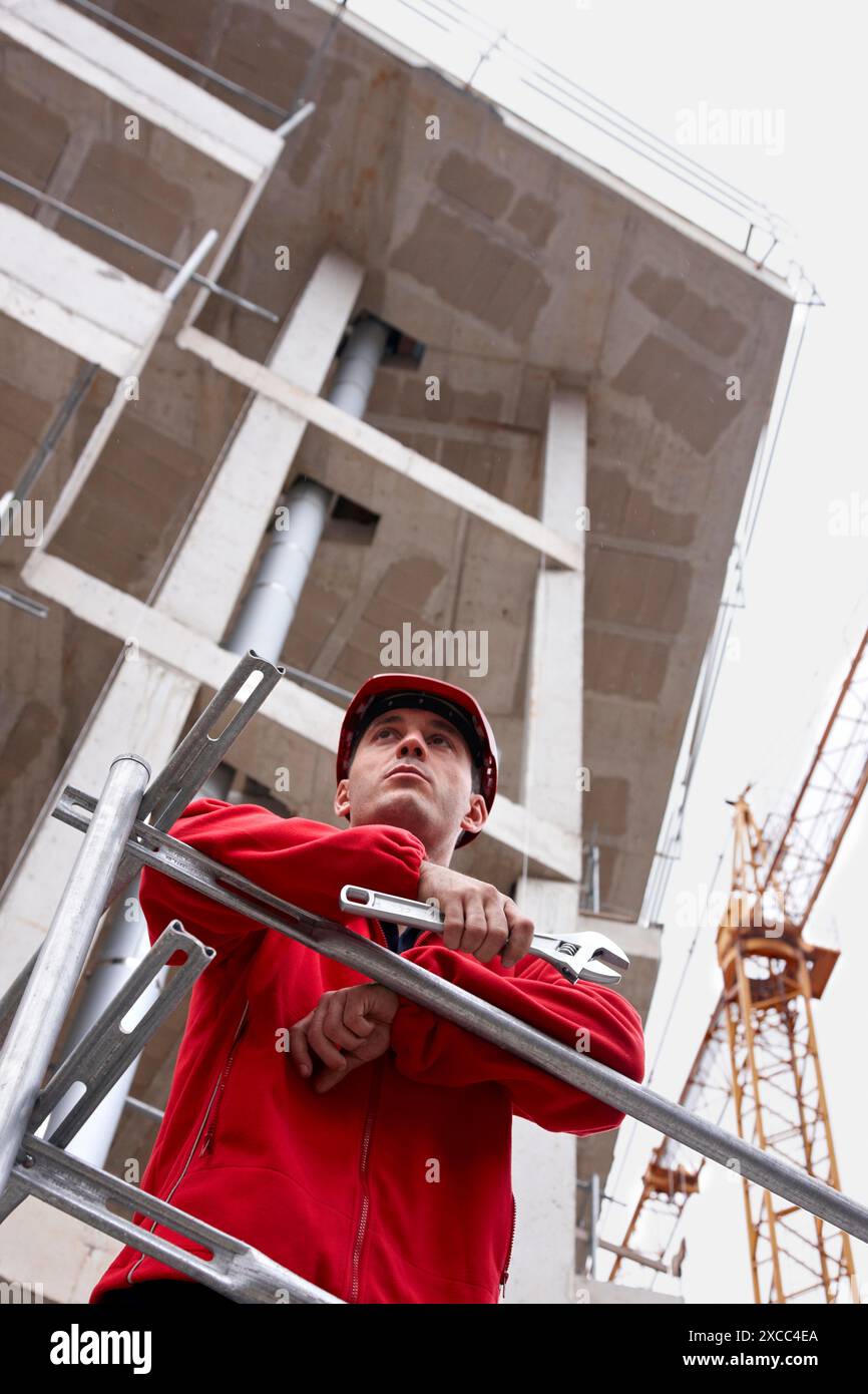 Worker holding adjustable spanner in a construction site Stock Photo ...