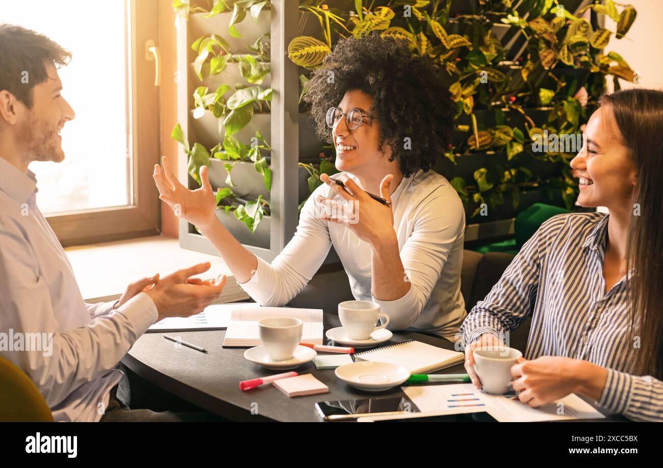 Inspired black guy explaining his great ideas to colleagues Stock Photo ...