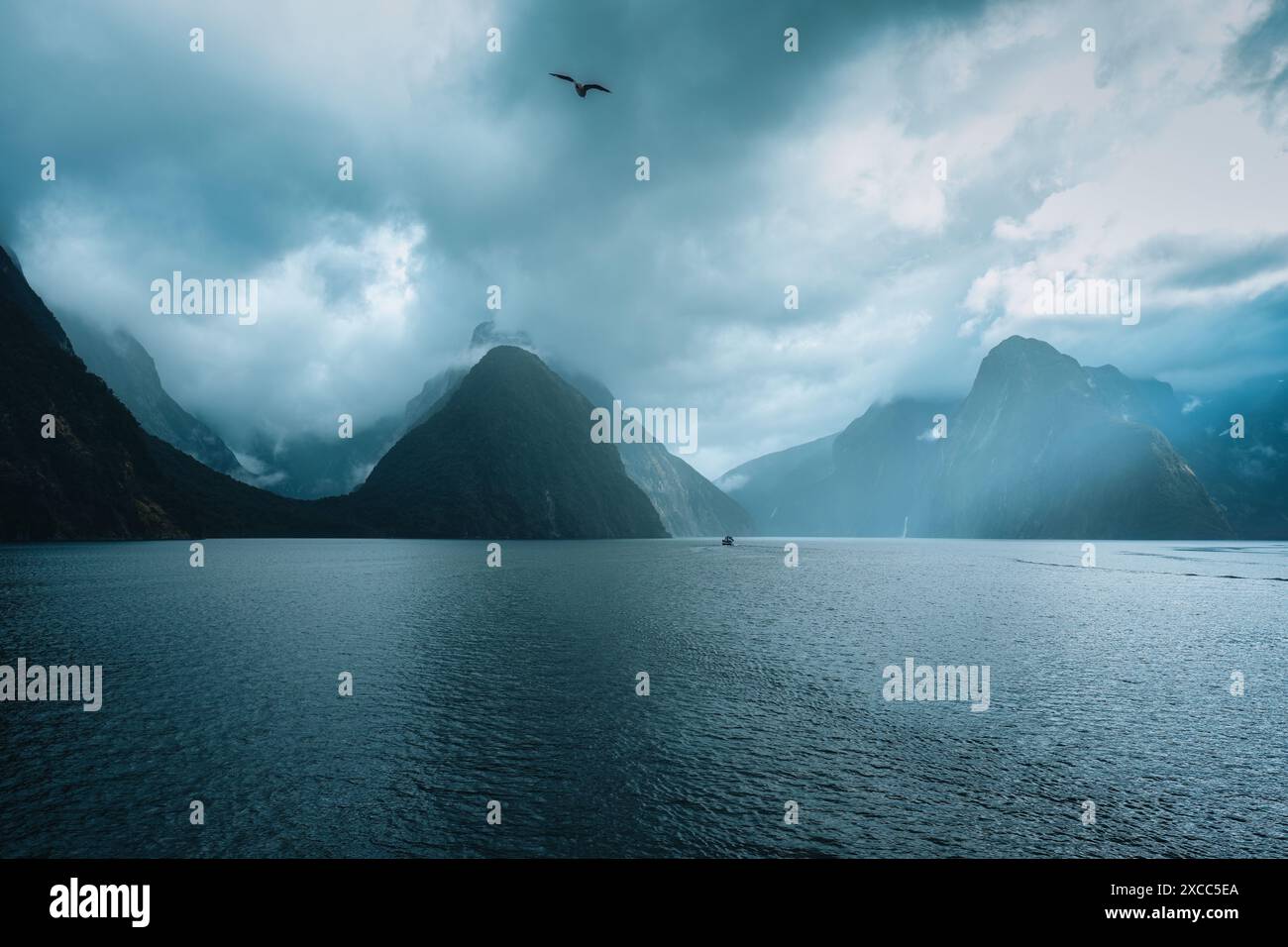 Mysterious landscape of Milford Sound with Mitre peak in moody weather ...