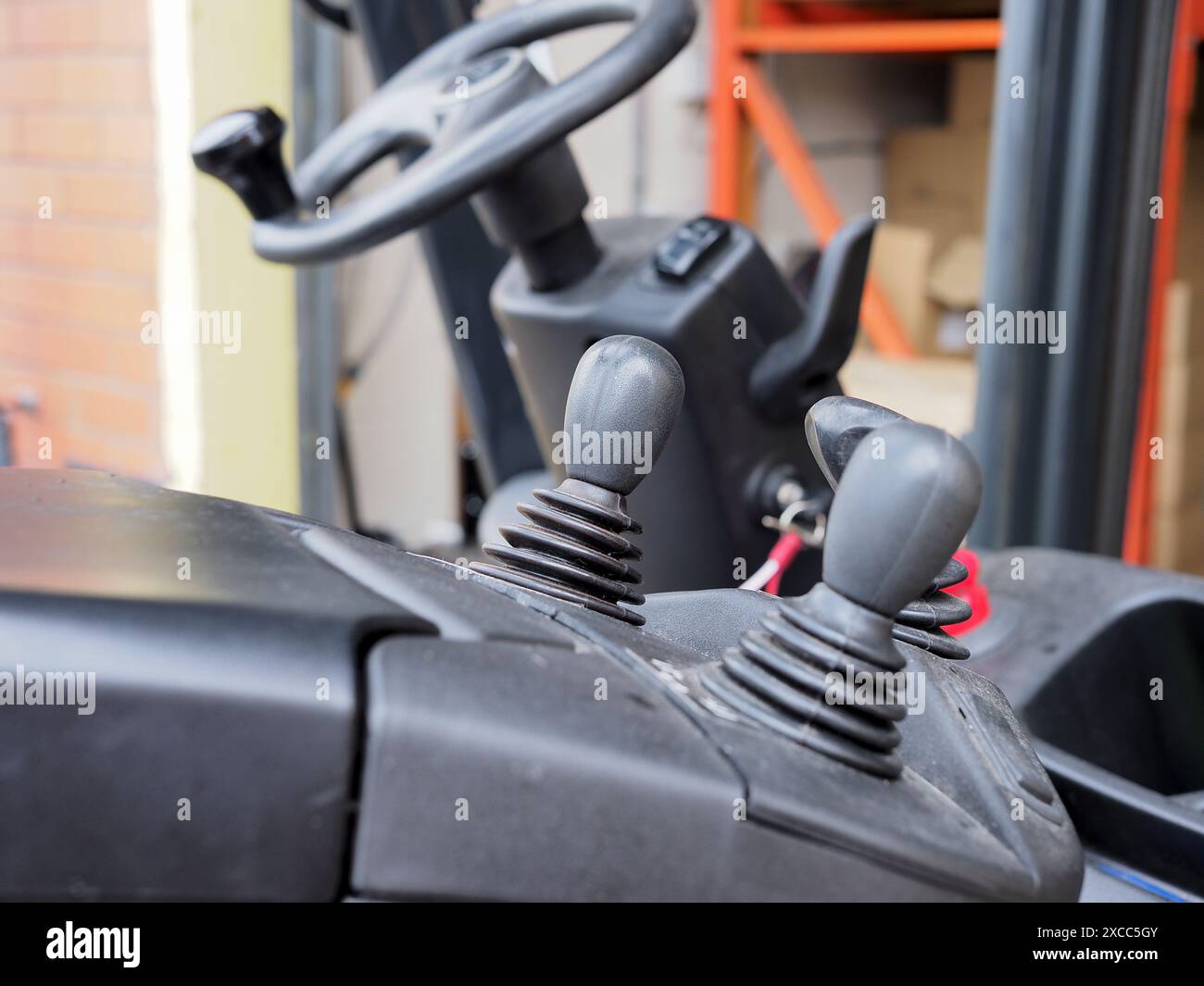 Close-up view of forklift controls showcasing levers and steering wheel ...