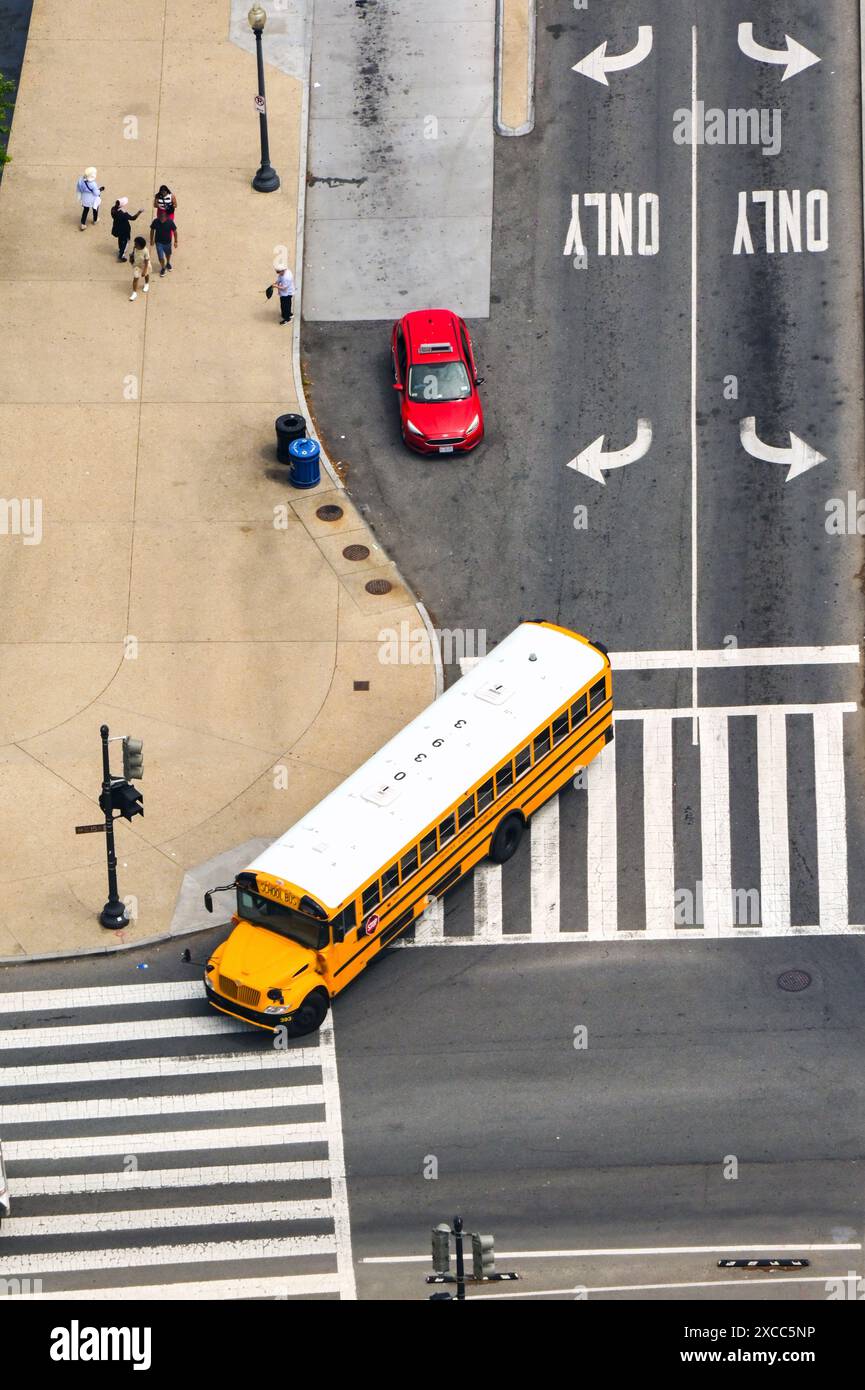 Washington DC, USA - 30 May 2024: Aerial view of a school bus turning a corner at a road ...