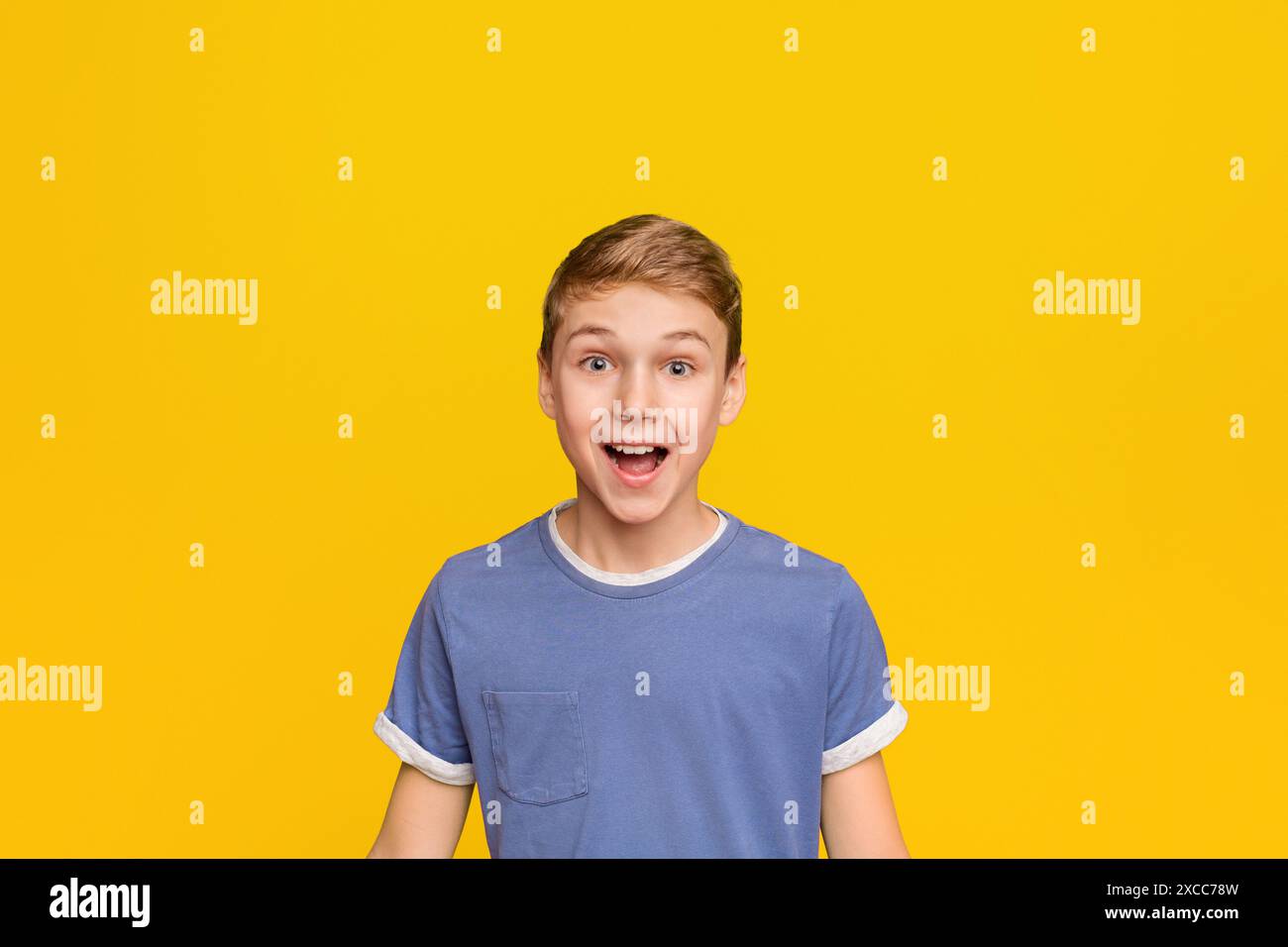 Shocked kid keeping mouth open and touching face Stock Photo - Alamy