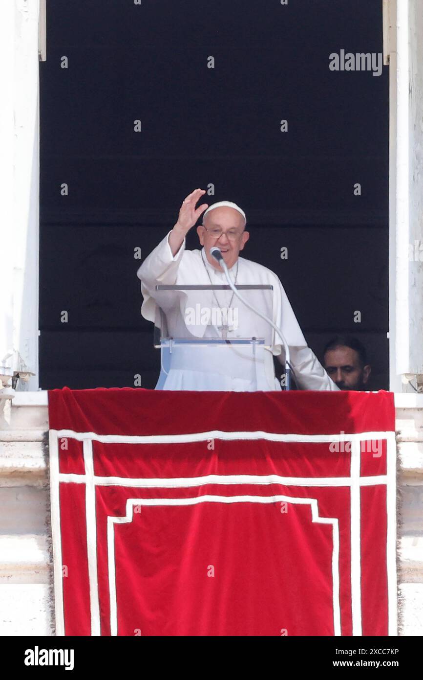 Pope Francis waves to the faithful after reciting the Angelus noon ...