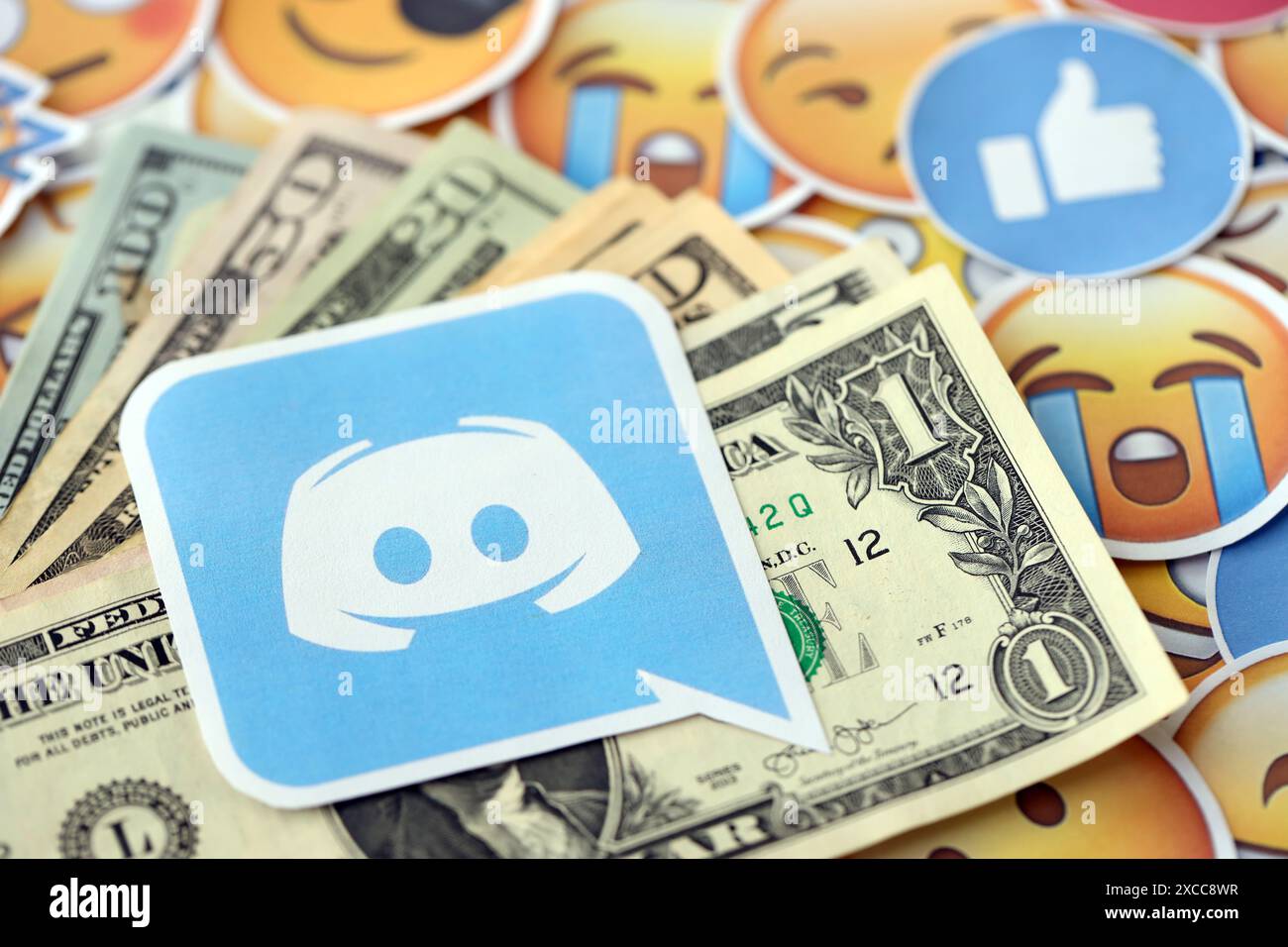 KYIV, UKRAINE - APRIL 20, 2024 Discord logo and many usd money bills ...