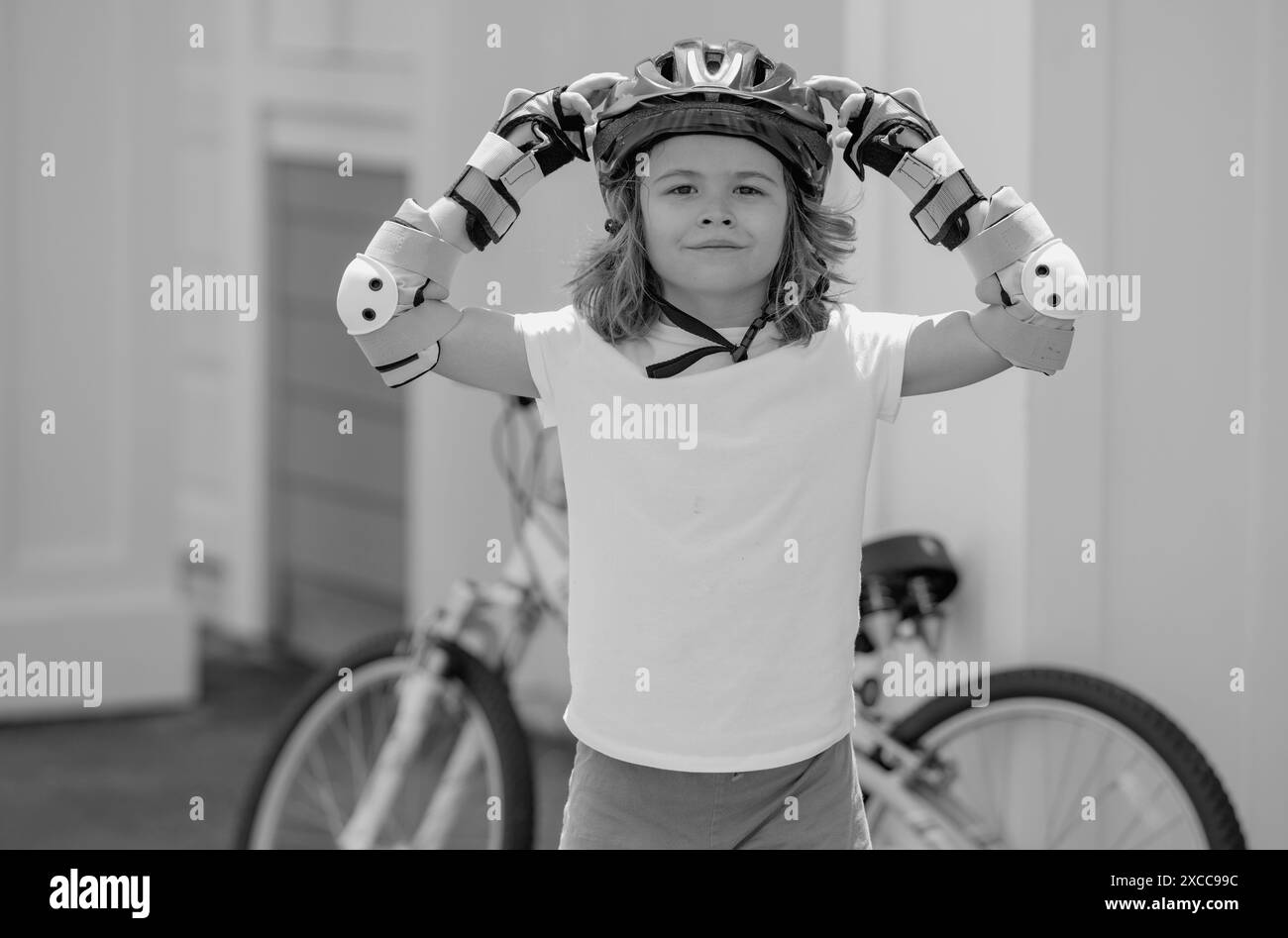 Kid riding on sporty bicycle in summer park. Child in safety helmet ...