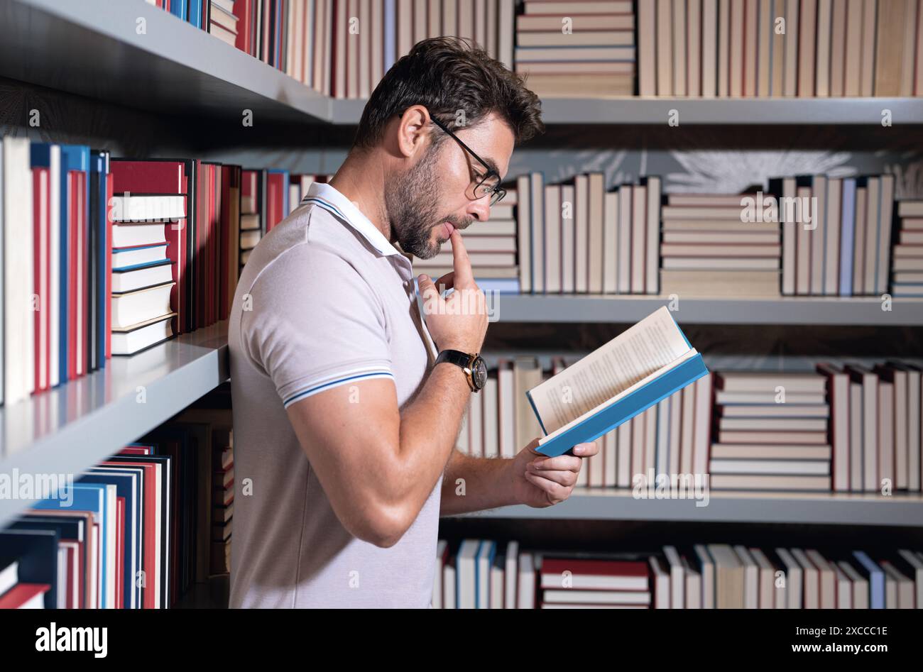 Portrait of professor with book in classroom. Handsome professor in ...
