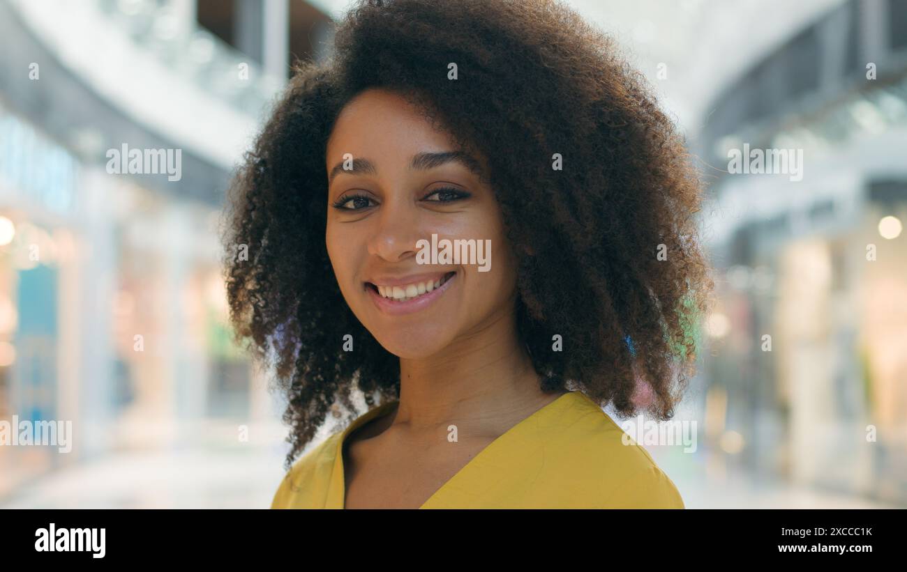African American woman turn head looking at camera smiling friendly ...