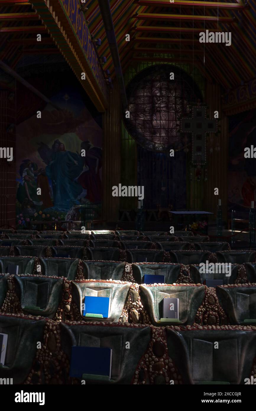 A Bible bathed in natural light within the serene, dark interior of a ...