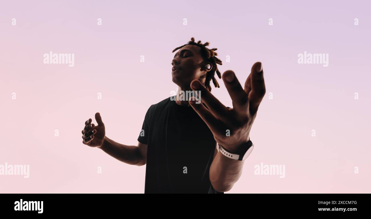 In a studio, a young male dancer with expressive body movement dances ...