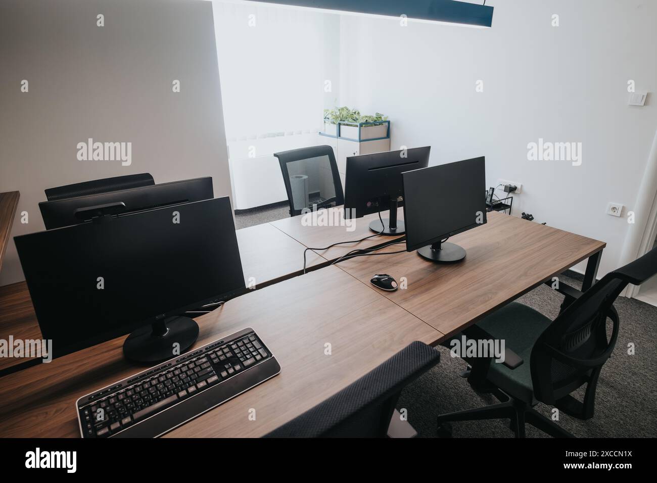 Modern office space with multiple monitors on a shared desk enhancing ...