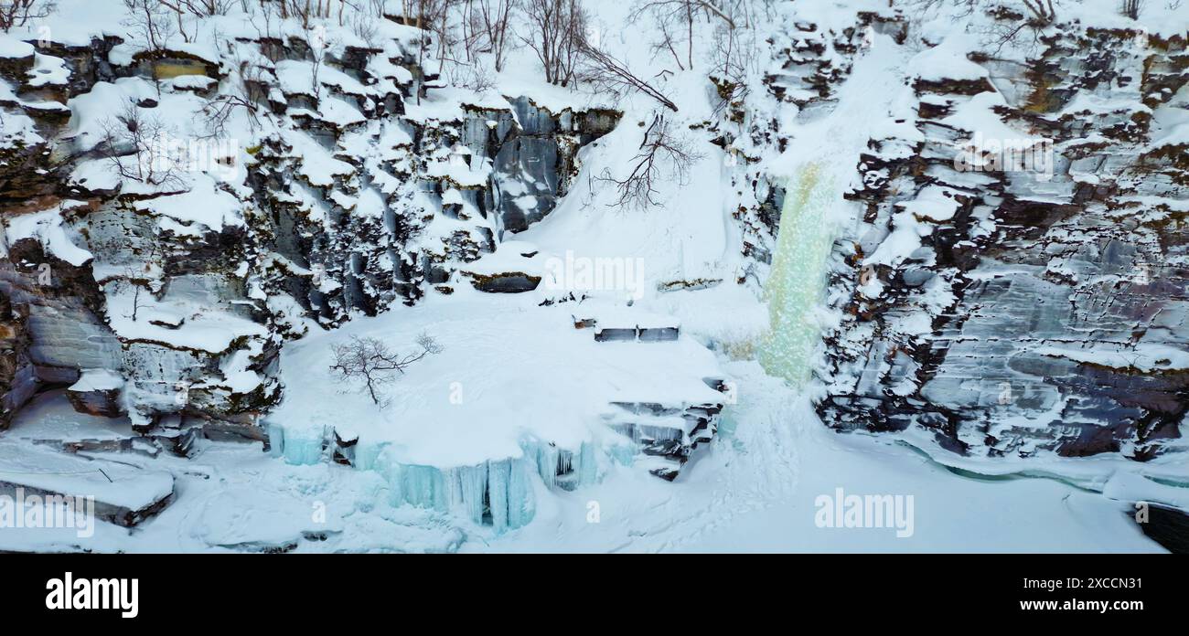Beautiful snow-covered rocky landscape with frozen waterfalls in the ...