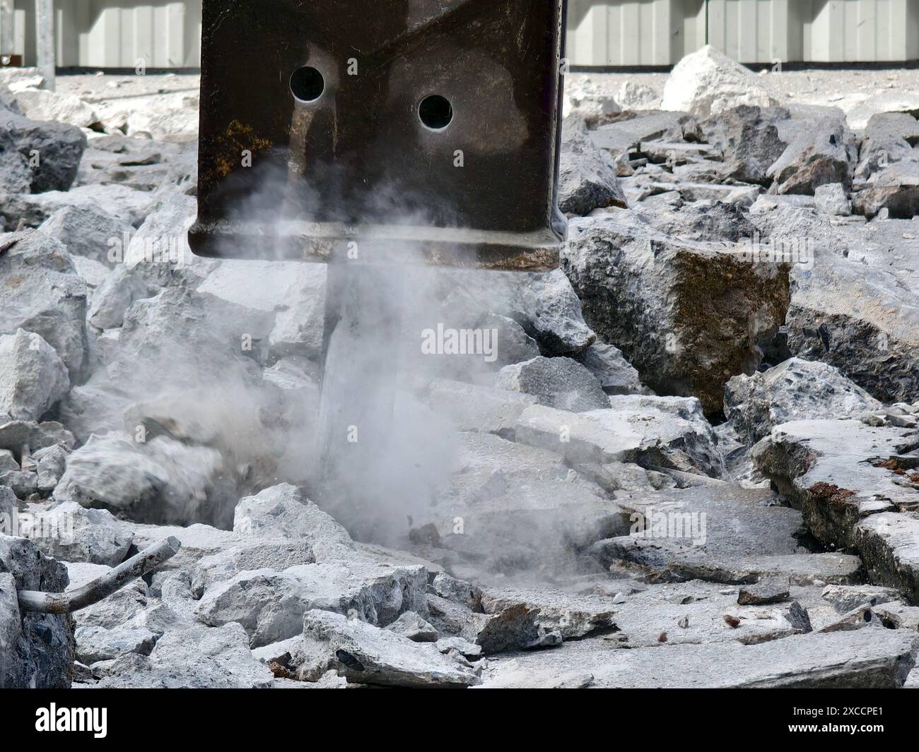 A hydraulic hammer breaking concrete at a construction site Stock Photo ...