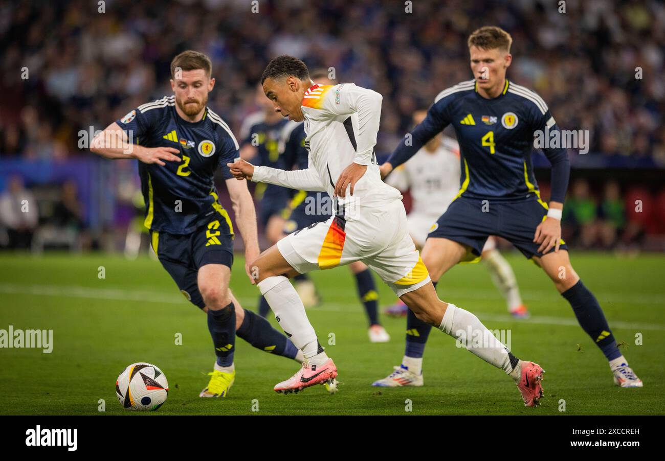 Munich, Germany. 14th Jun 2024. Jamal Musiala (DFB) Tony Ralston (Sco ...