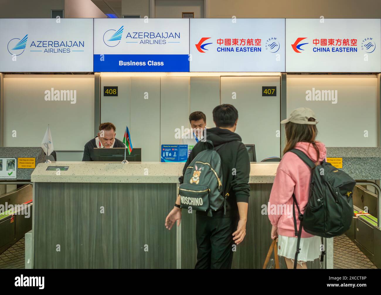 Chinese passengers queue to check in for a China Eastern flight to ...