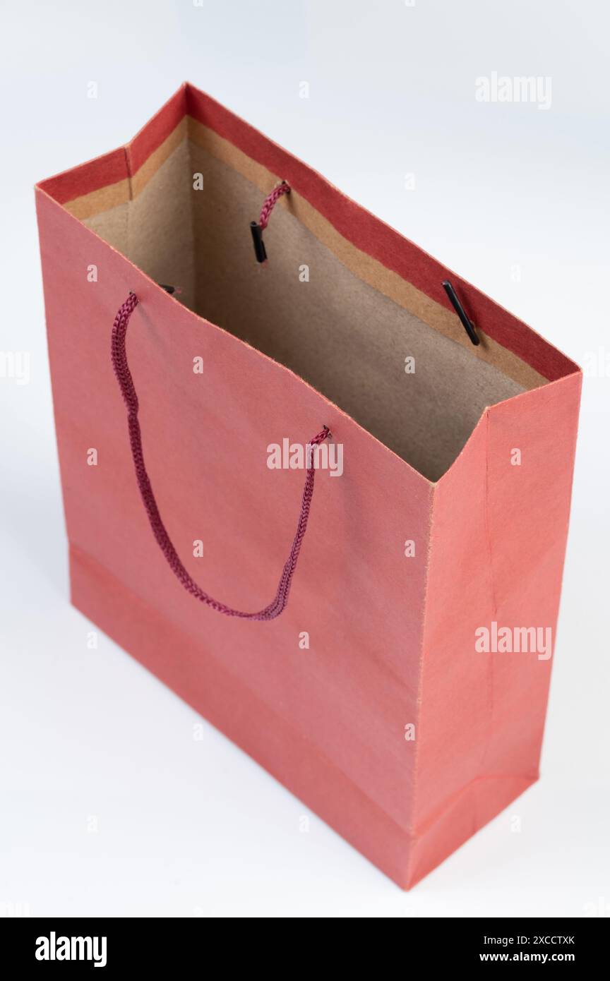 Pink paper bag with handles perspective view isolated on white studio ...