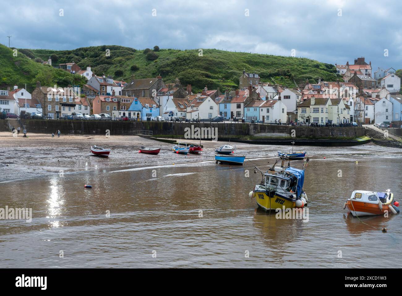 Staithes, view of the harbour with boats in the pretty fishing village ...