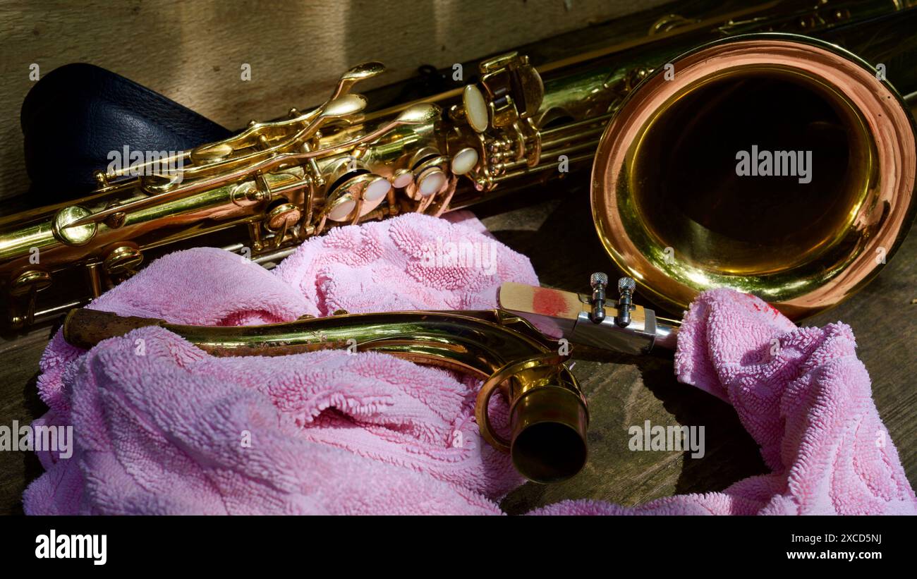 A tenor saxophone, neck, mouthpiece, towel. A bloody mouthpiece caused ...