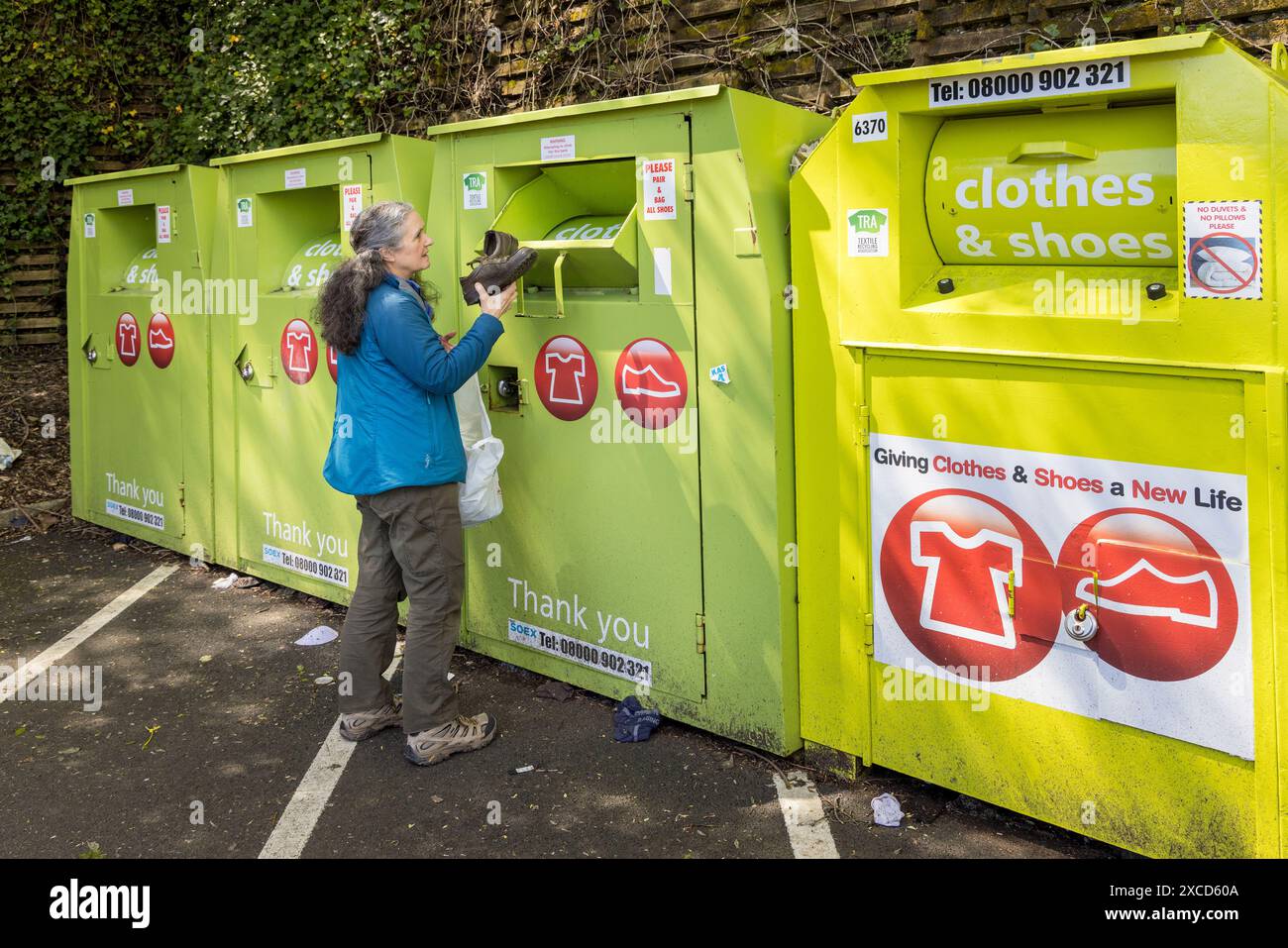 Cl.othes and shoes bank for recycling with person putting in some shoes ...