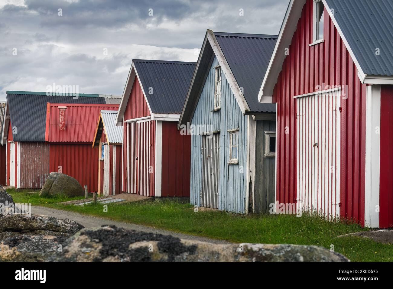 Traditional rorbuer huts, painted in vibrant colors with contrasting ...