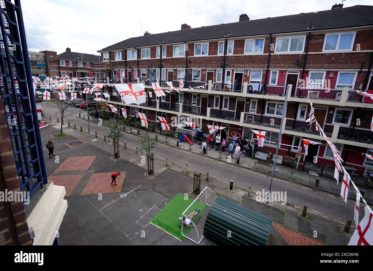 Children playing football surrounded by flags at the Kirby Estate ...