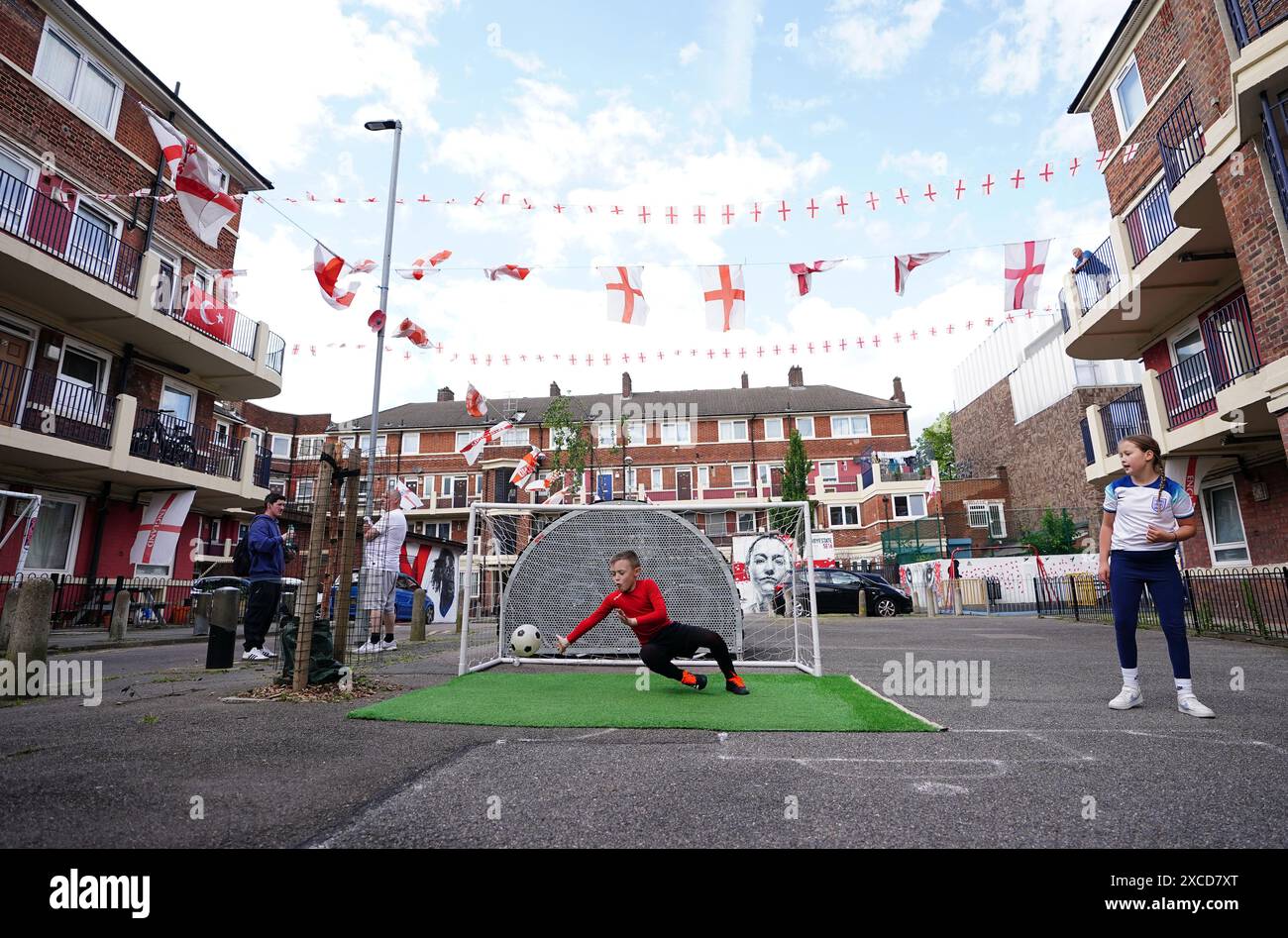 Children playing football surrounded by flags at the Kirby Estate ...
