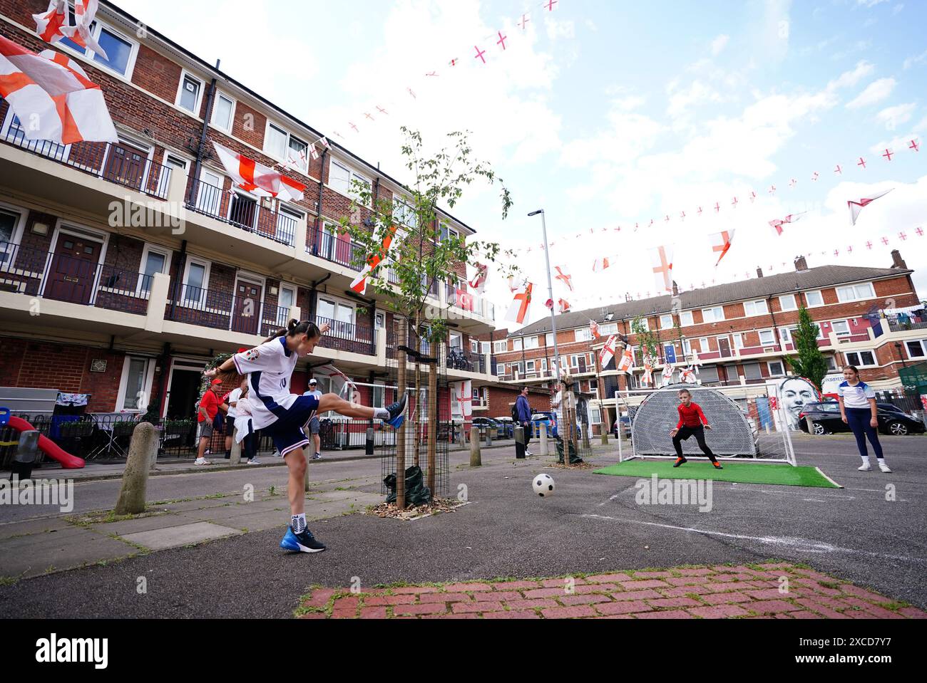 Children playing football surrounded by flags at the Kirby Estate ...