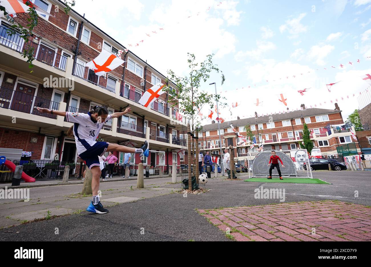 Children playing football surrounded by flags at the Kirby Estate ...