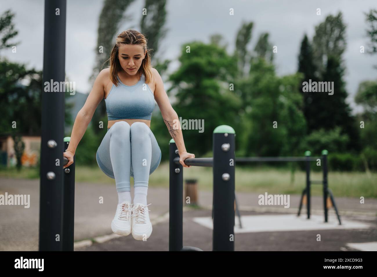 Woman performing outdoor calisthenics hi-res stock photography and ...