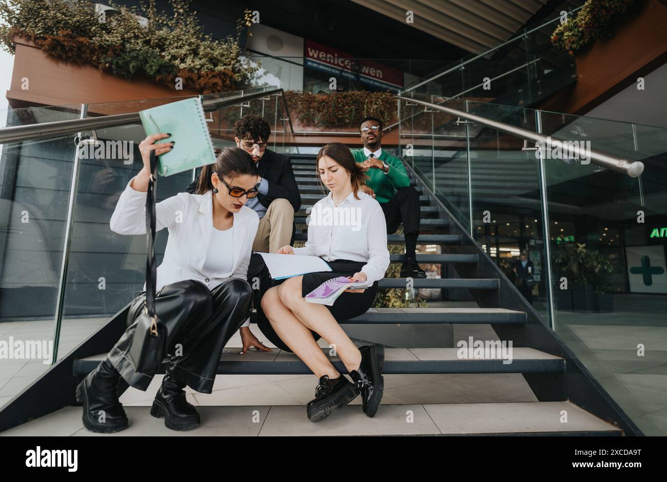 Dynamic startup team engaged in an outdoor business meeting Stock Photo ...