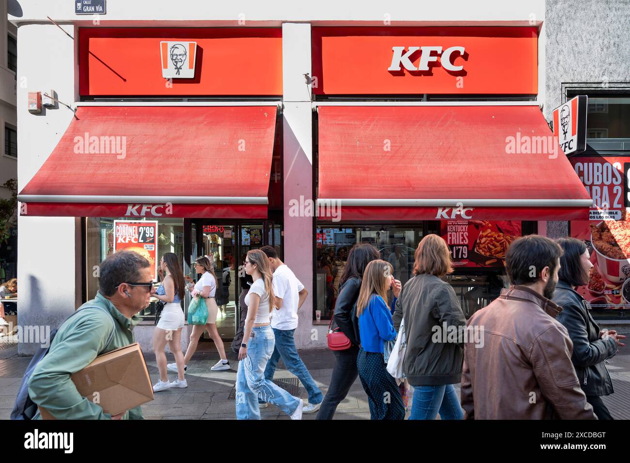Pedestrians walk past the American fast food chicken restaurant chain ...