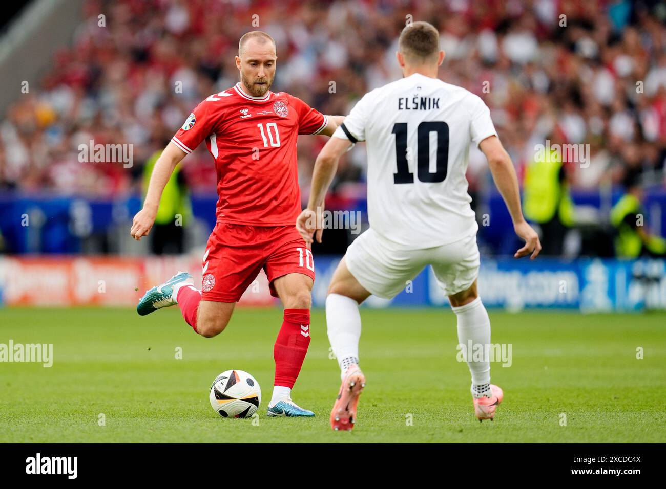Denmark's Christian Eriksen (left) and Slovenia's Timi Elsnik in action ...