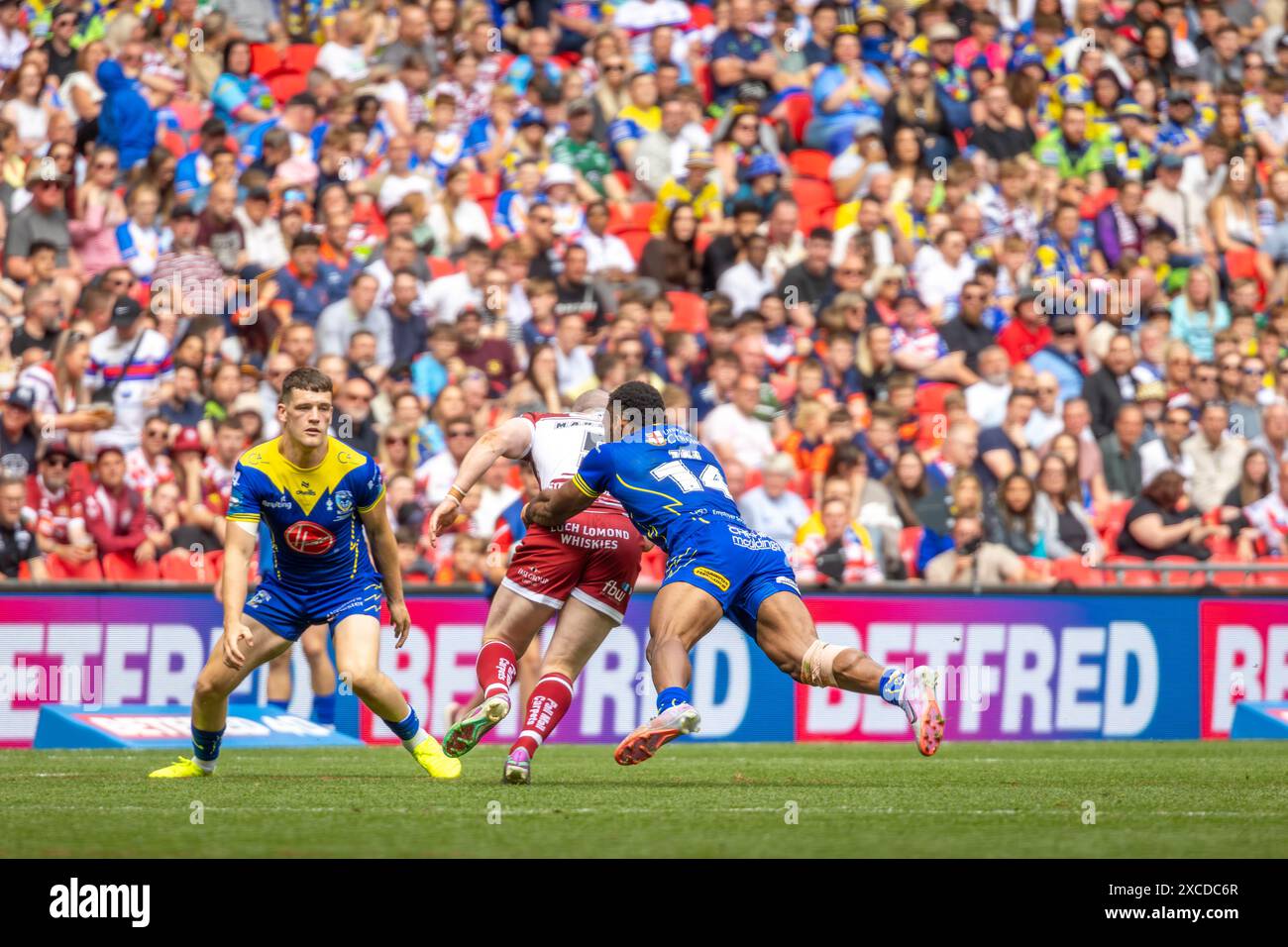 The 2024 Betfred Challenge Cup Final. Rodrick Tai grabs hold of Liam ...