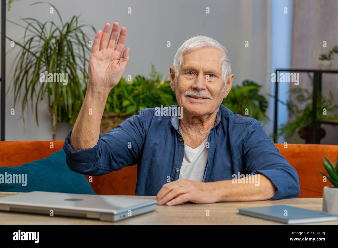 Hello. Senior man smiling friendly at camera waving hands gesturing ...