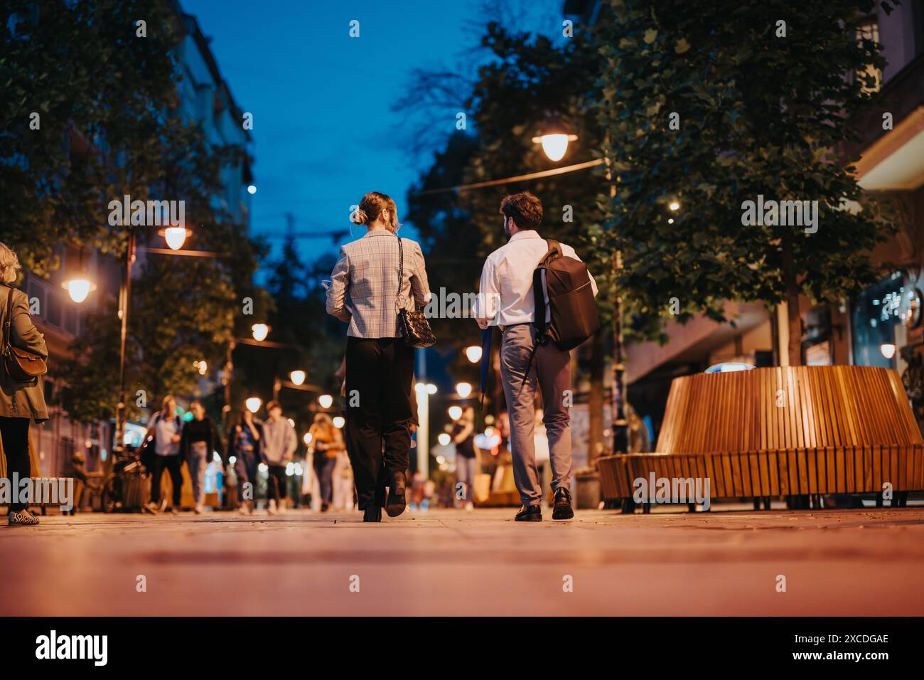 Evening urban scene with people walking on a city street Stock Photo ...
